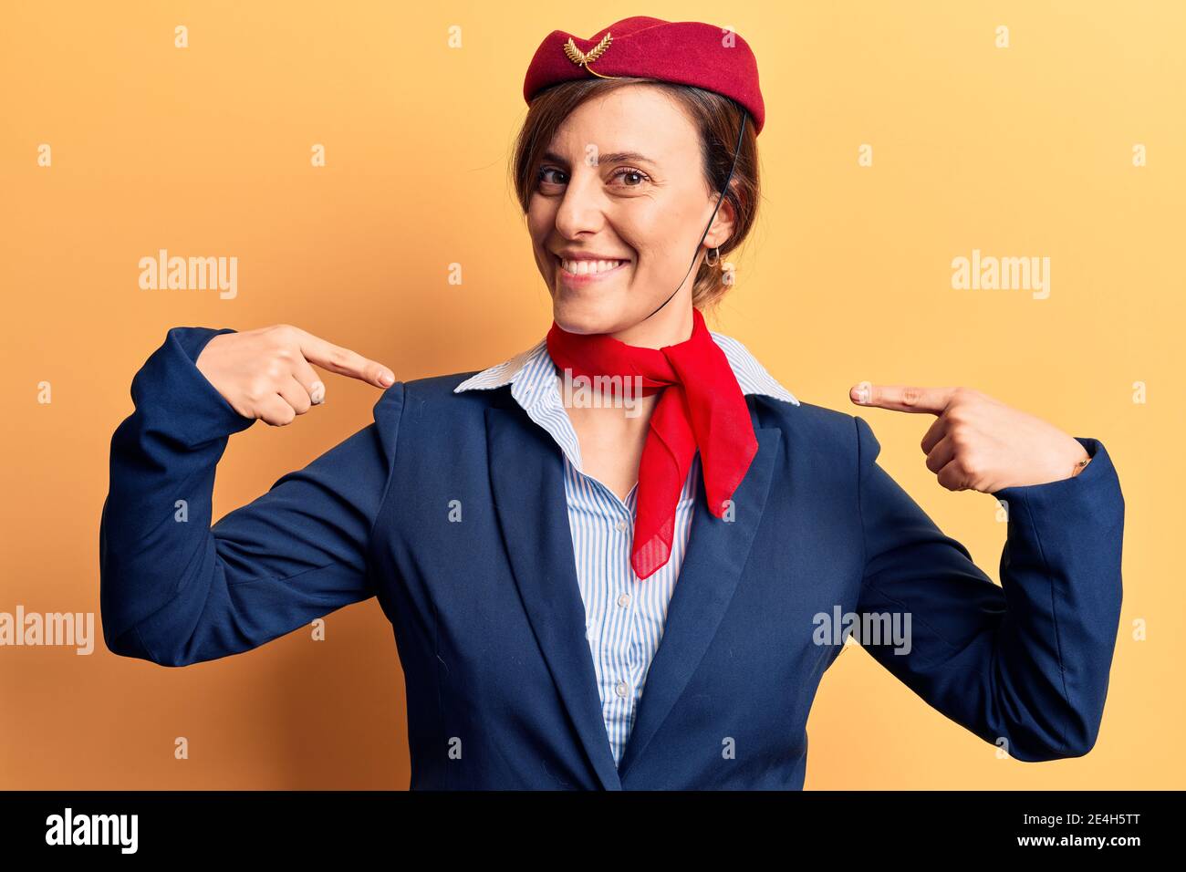 Young beautiful woman wearing stewardess uniform looking confident with ...