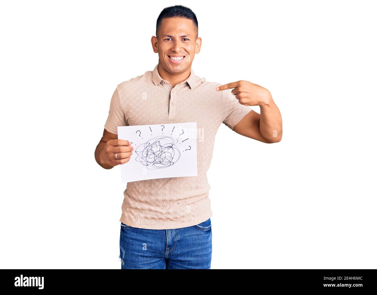 Young handsome latin man holding scribble draw pointing finger to one ...