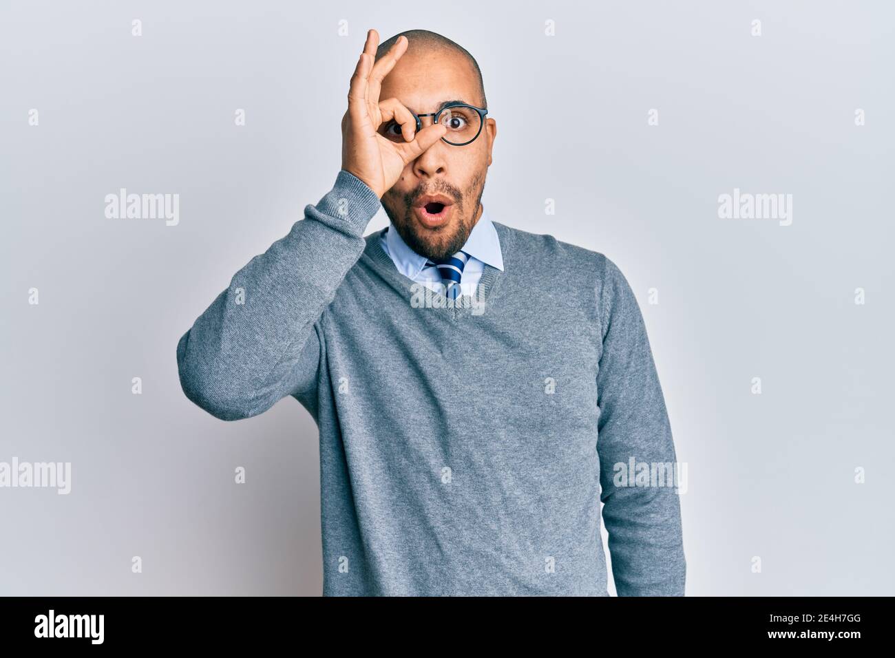 Hispanic adult man wearing glasses and business style doing ok gesture ...