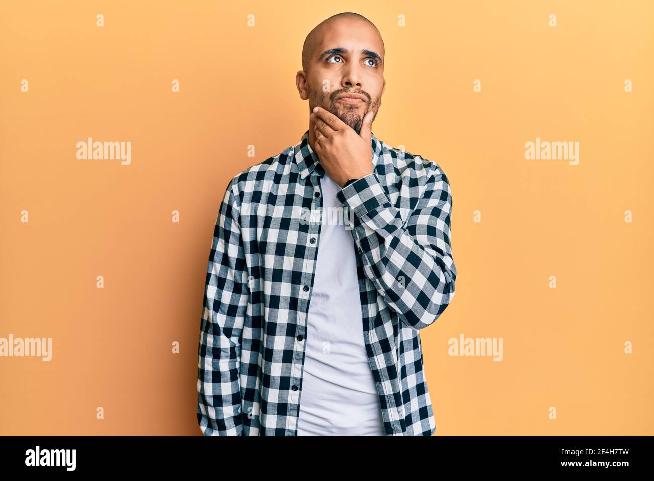 Hispanic adult man wearing casual clothes thinking concentrated about ...