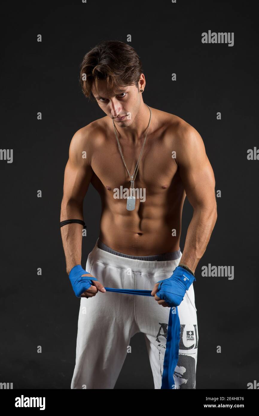 Studio portrait of a muscular built italian young man Stock Photo - Alamy