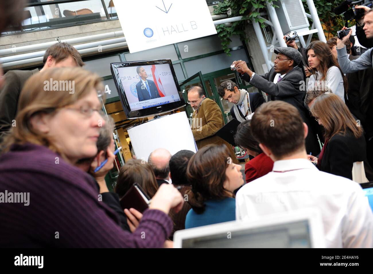 COP15 participants follow US president Barack Obama's speech on a TV ...