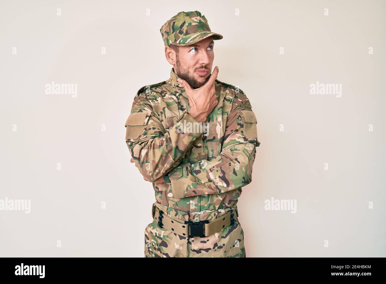 Young caucasian man wearing camouflage army uniform thinking worried ...