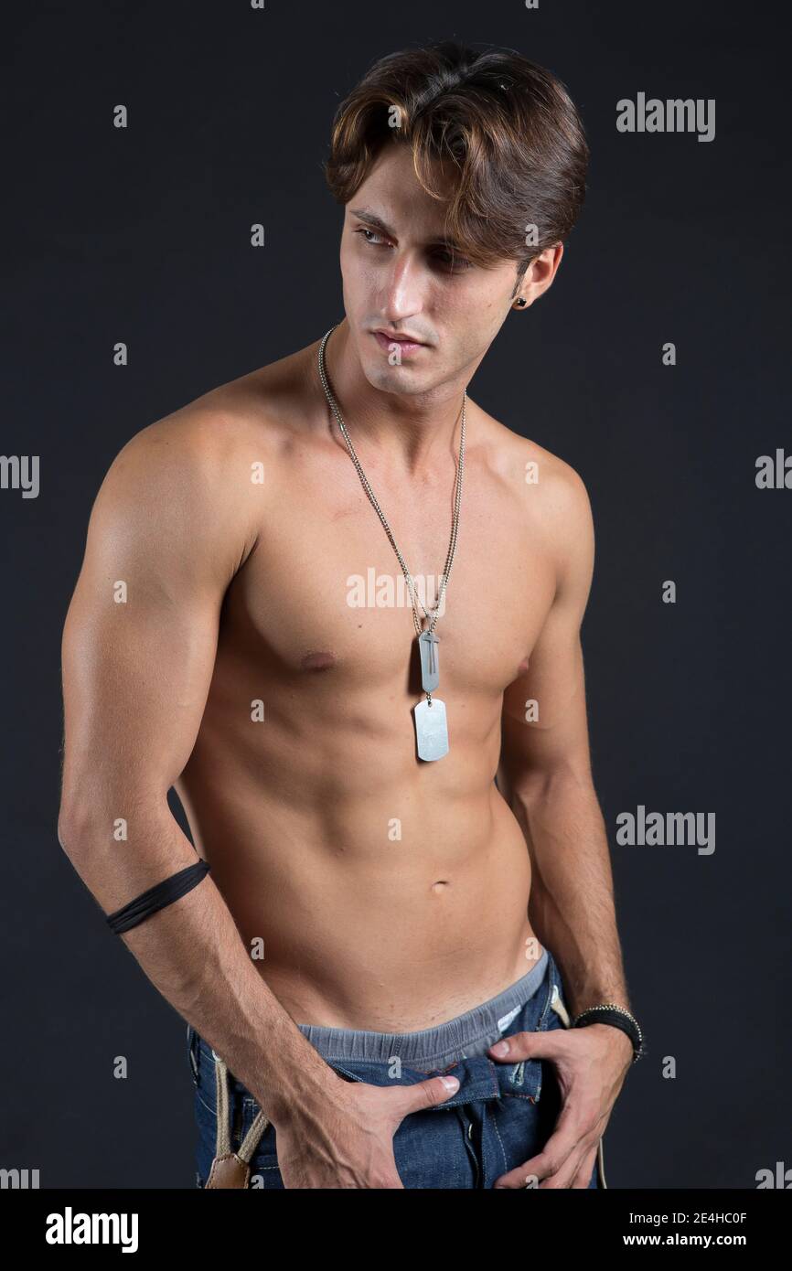 Studio portrait of a muscular built italian young man Stock Photo - Alamy