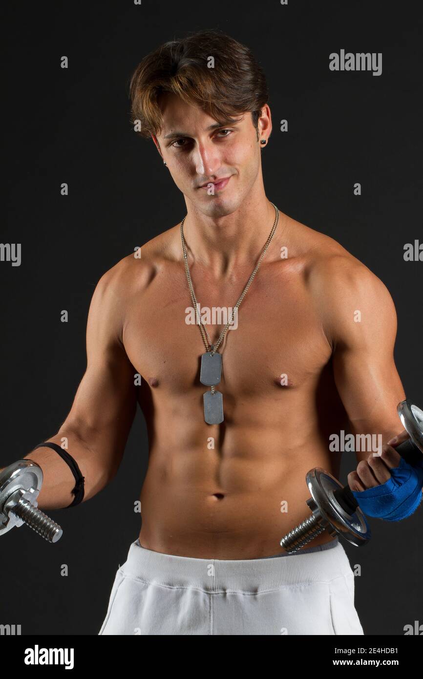Studio portrait of a muscular built italian young man Stock Photo - Alamy
