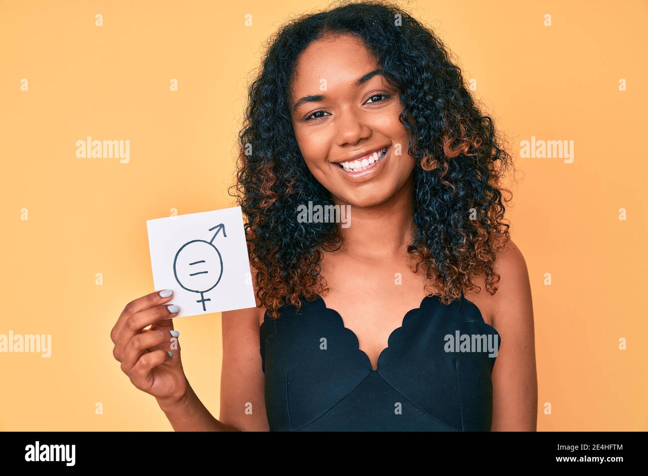 Young african american woman holding we are equal paper looking ...