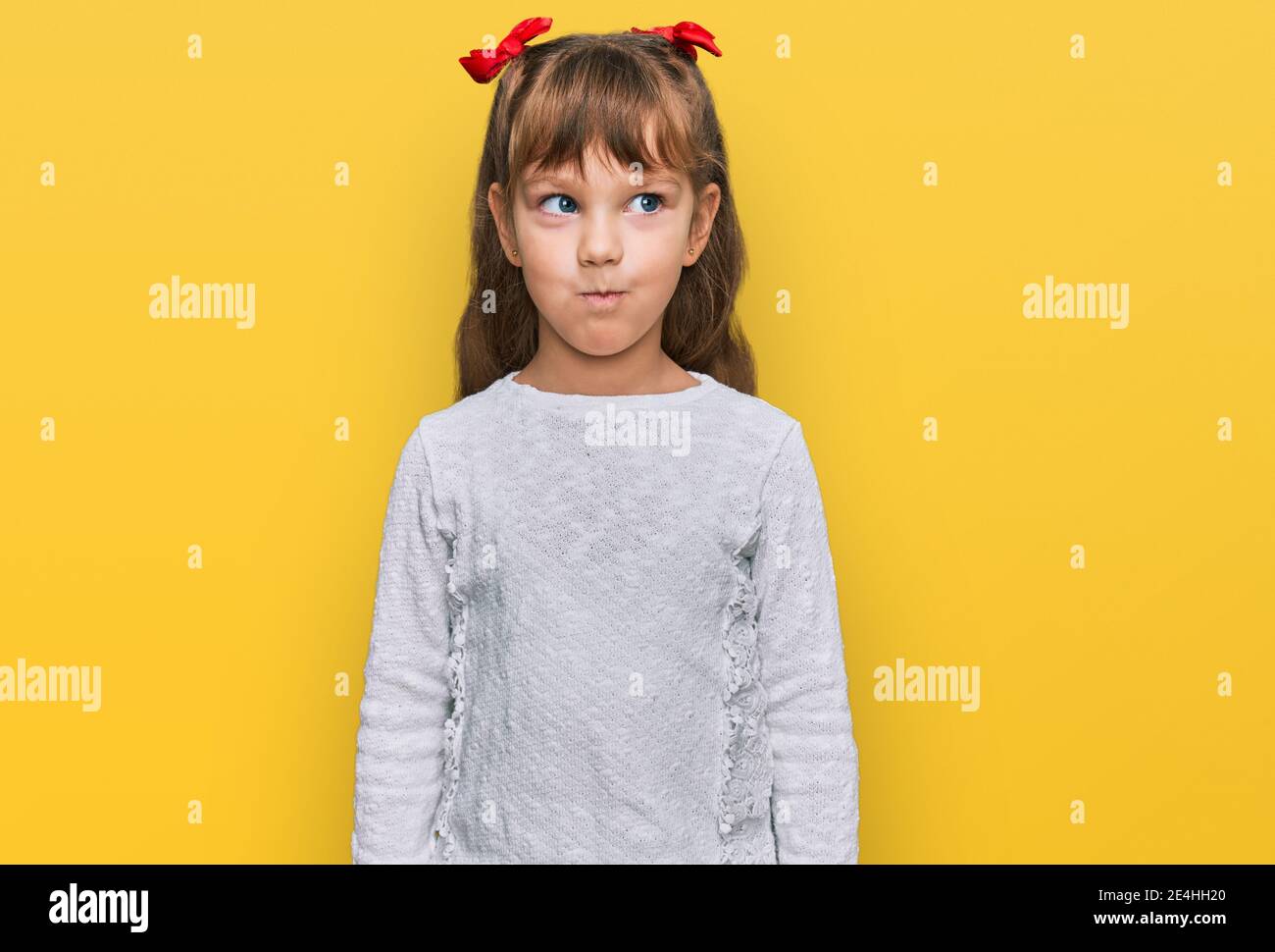 Little caucasian girl kid wearing casual clothes puffing cheeks with ...