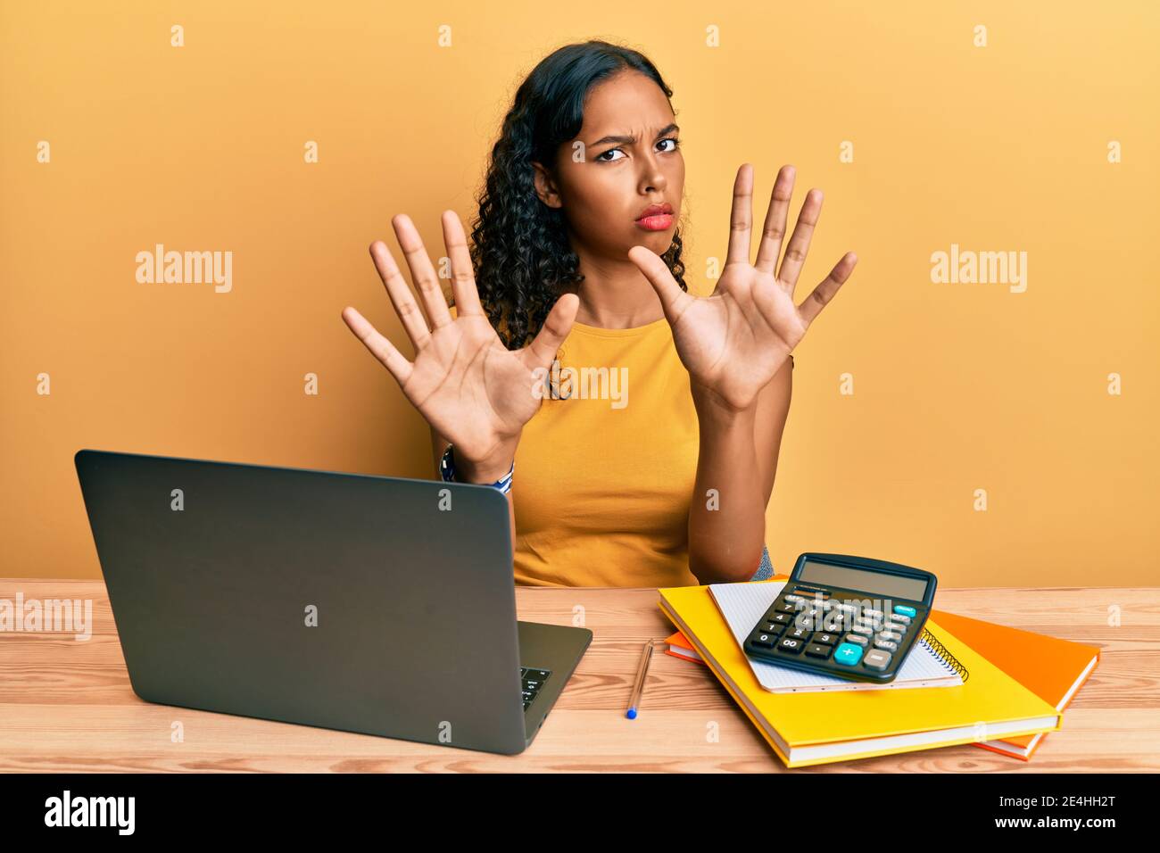 Young african american girl working at the office with laptop and ...
