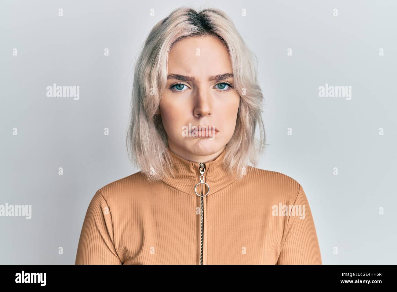Young blonde girl wearing casual clothes depressed and worry for ...