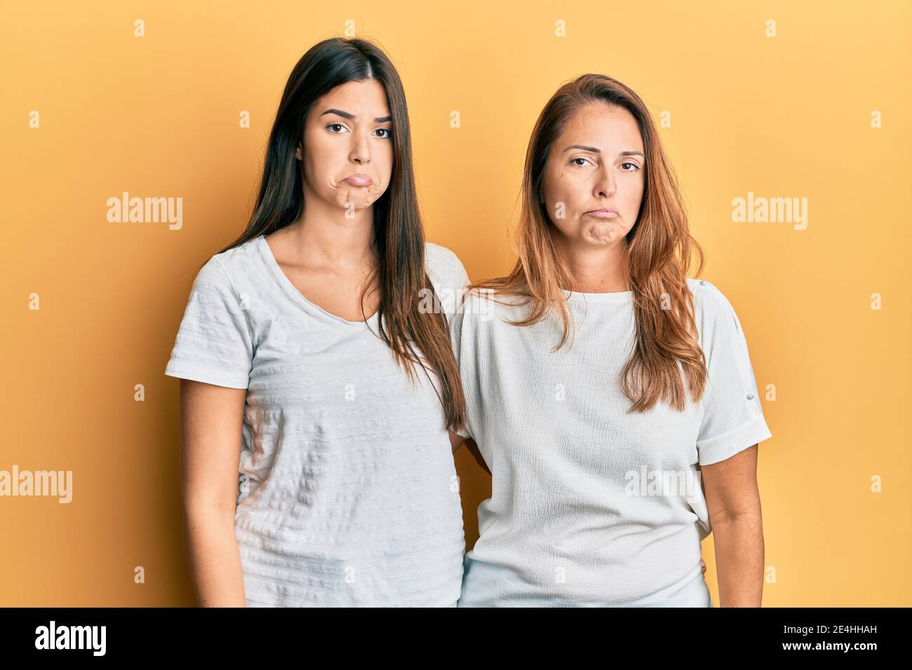 Hispanic family of mother and daughter wearing casual white tshirt ...