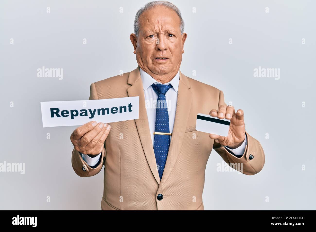 Senior caucasian man holding payment word paper and credit card ...