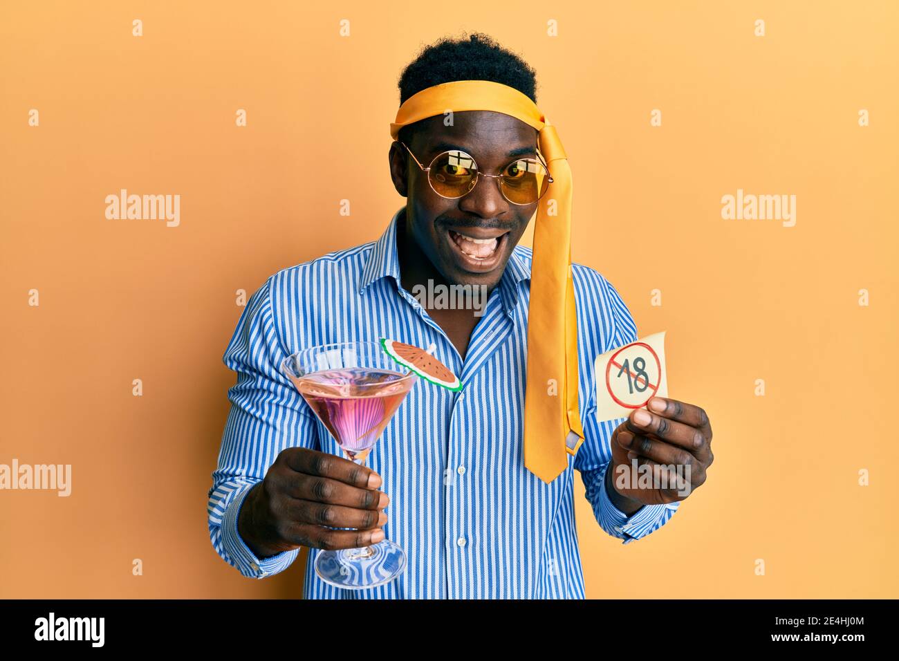 Handsome black man drunk wearing tie over head drinking cocktail ...