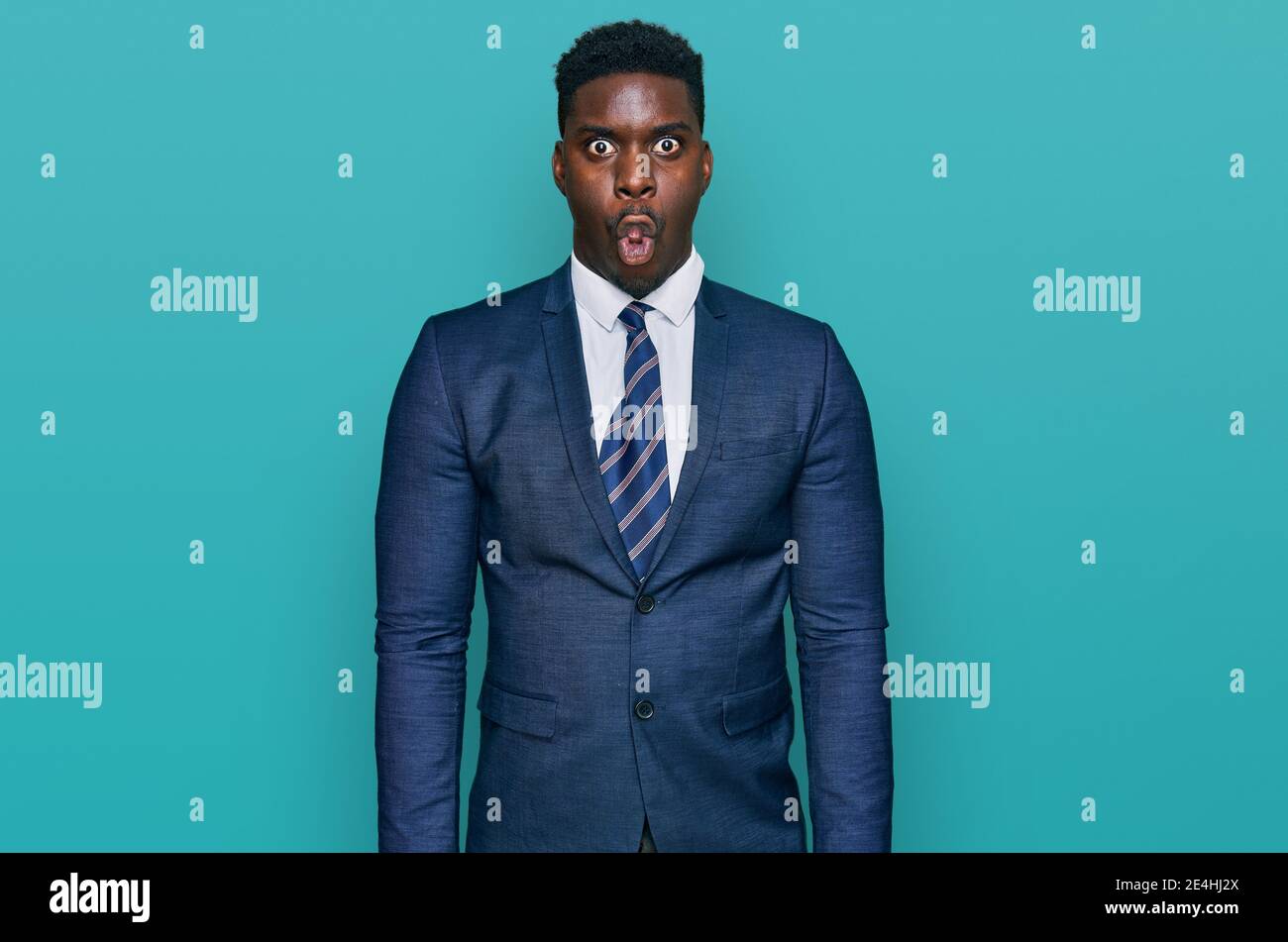 Handsome business black man wearing business suit and tie afraid and ...