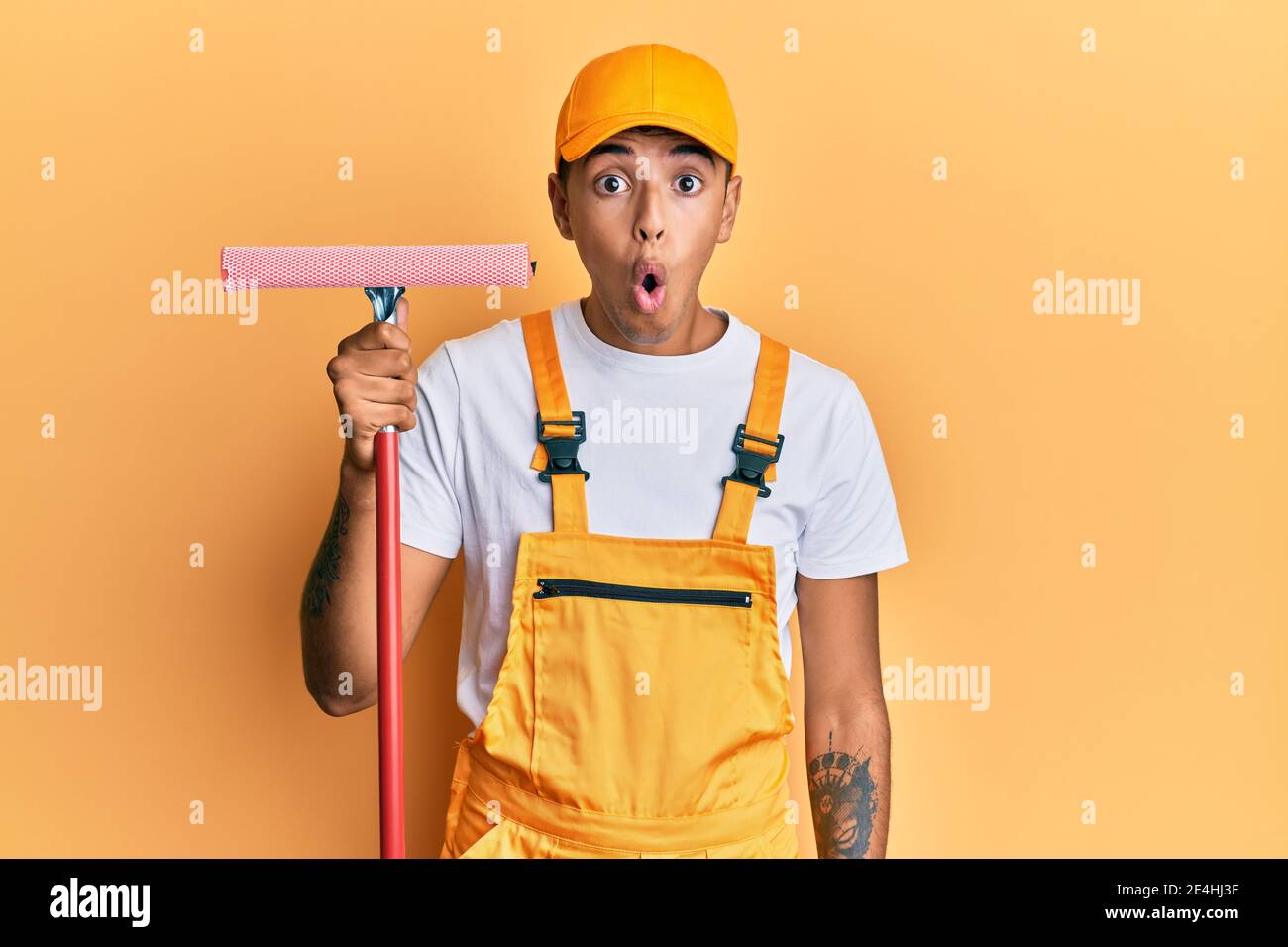 Young handsome african american man window cleaner holding glass washer ...