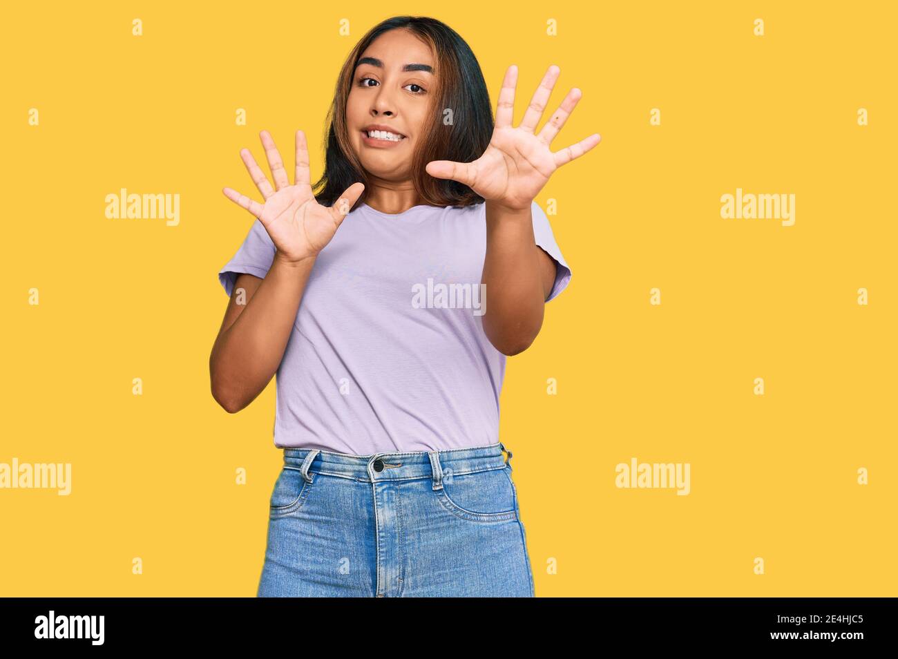 Young latin woman wearing casual clothes afraid and terrified with fear ...