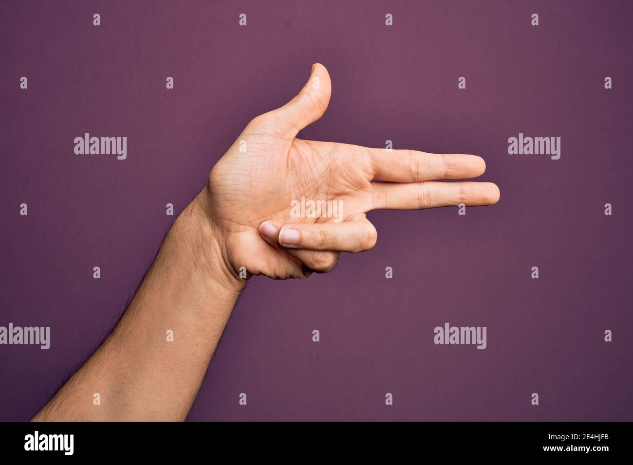 Hand of caucasian young man showing fingers over isolated purple ...