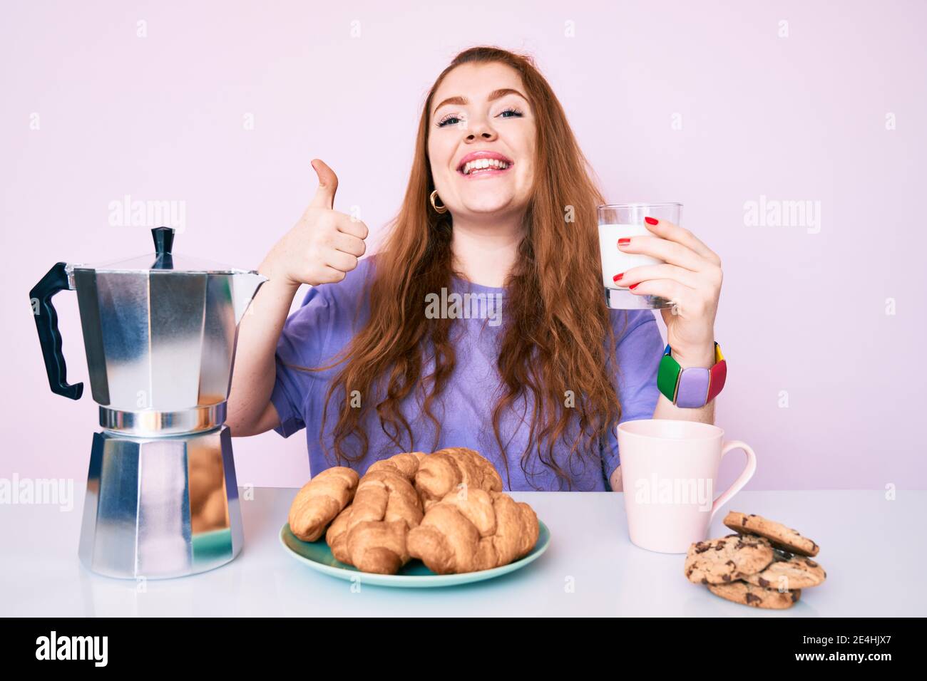 Young redhead woman eating breakfast celebrating mad and crazy for ...