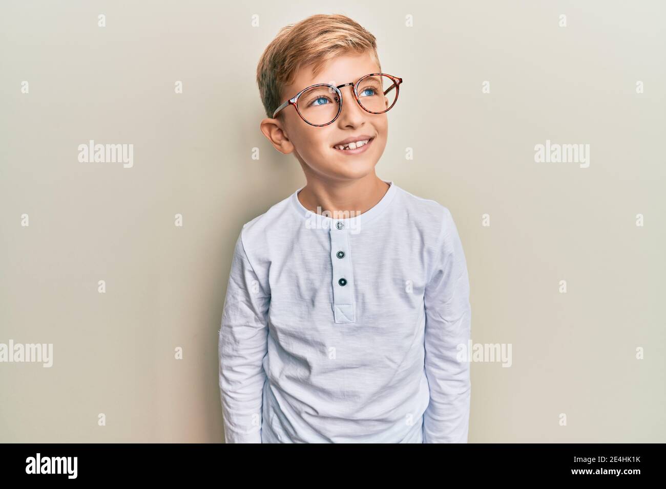 Little caucasian boy kid wearing casual clothes and glasses looking to ...