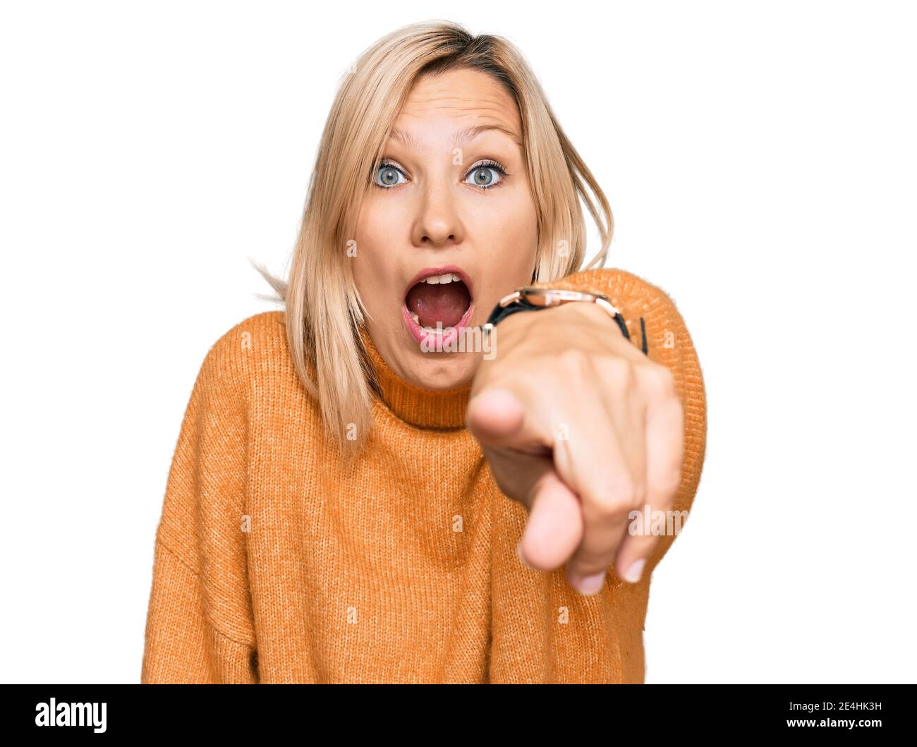 Middle age caucasian woman wearing casual winter sweater pointing ...