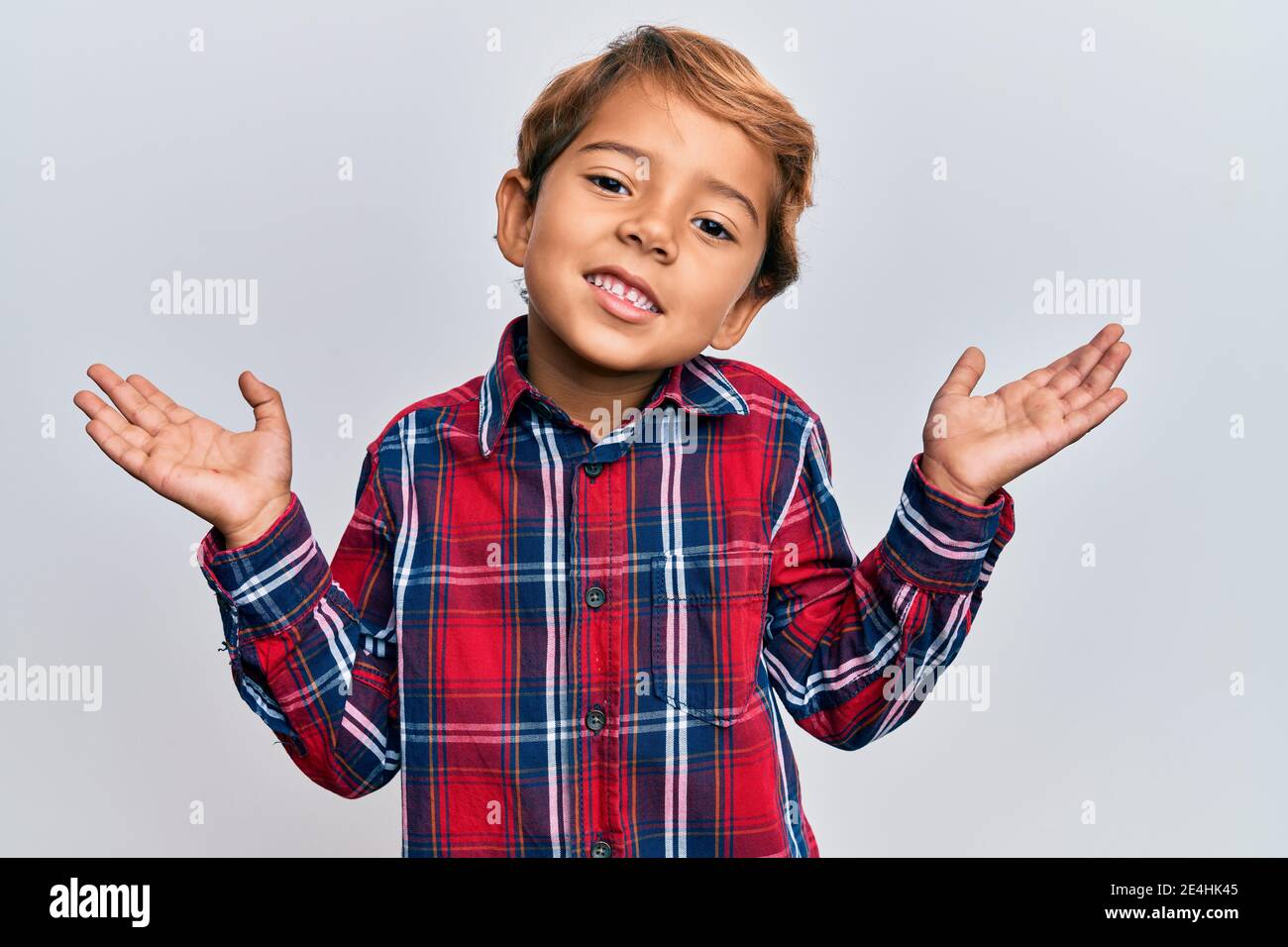Adorable latin kid wearing casual clothes clueless and confused with ...