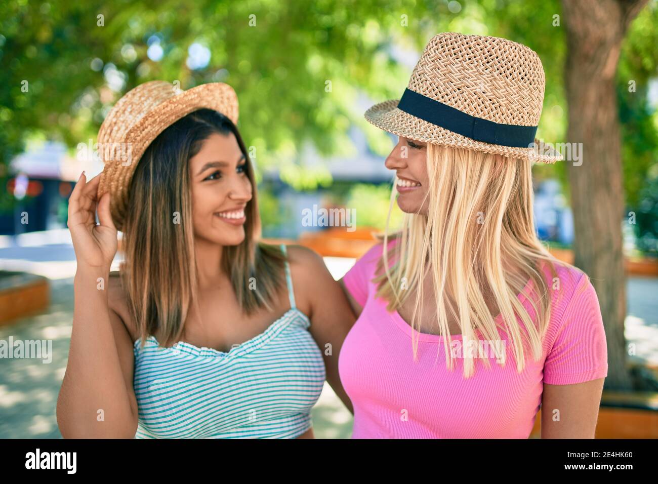 Two beautiful and young girl friends together having fun at the city ...