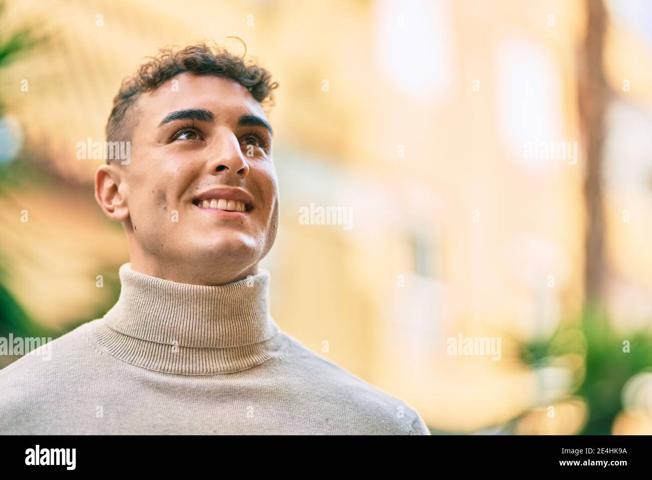 Young hispanic man smiling happy standing at the city Stock Photo - Alamy