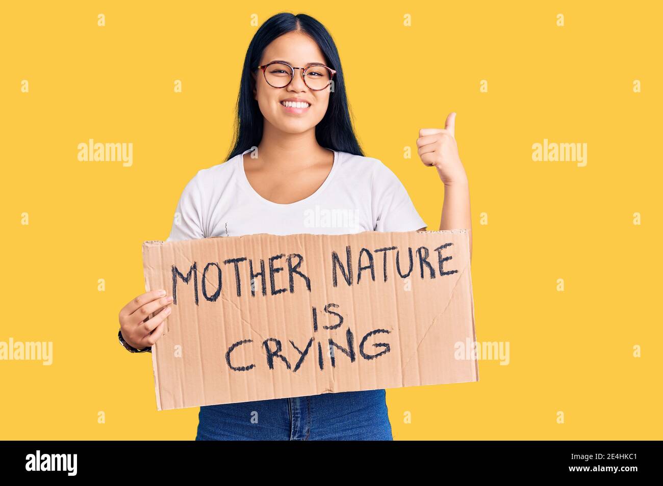 Young beautiful asian girl holding mother nature is crying protest ...