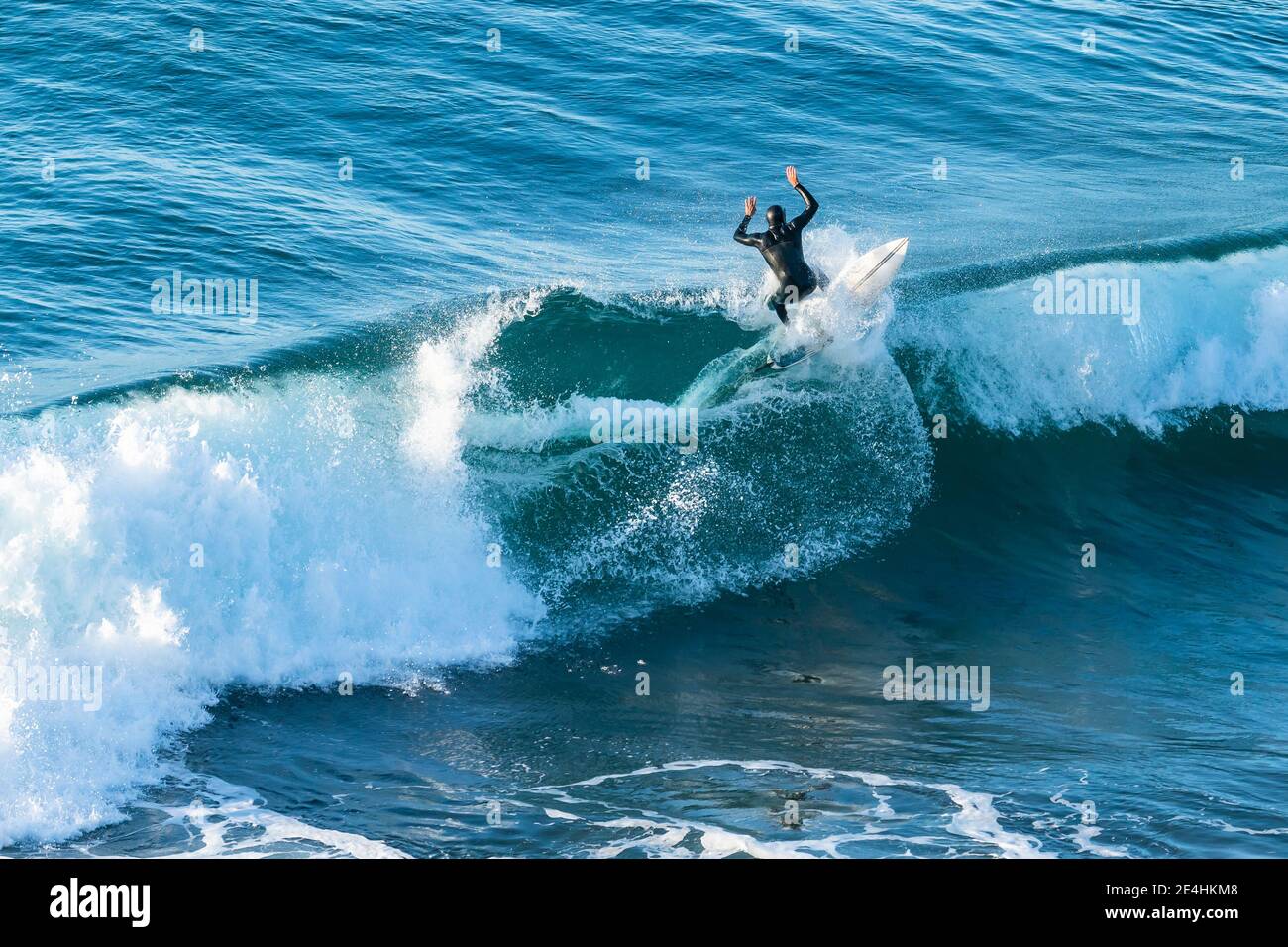 Surfers riding a big wave in the Pacific Ocean at Puertecillo spot in ...