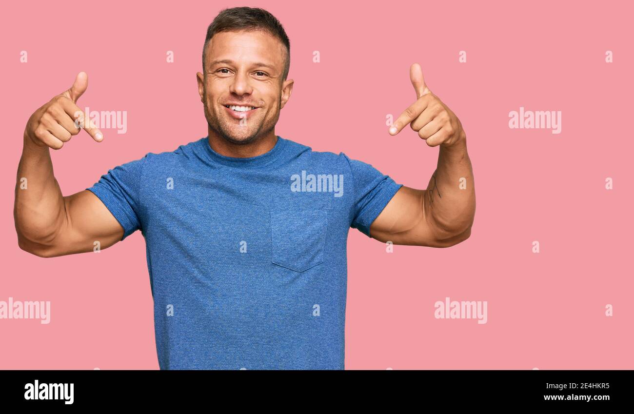 Handsome muscle man wearing casual clothes looking confident with smile ...