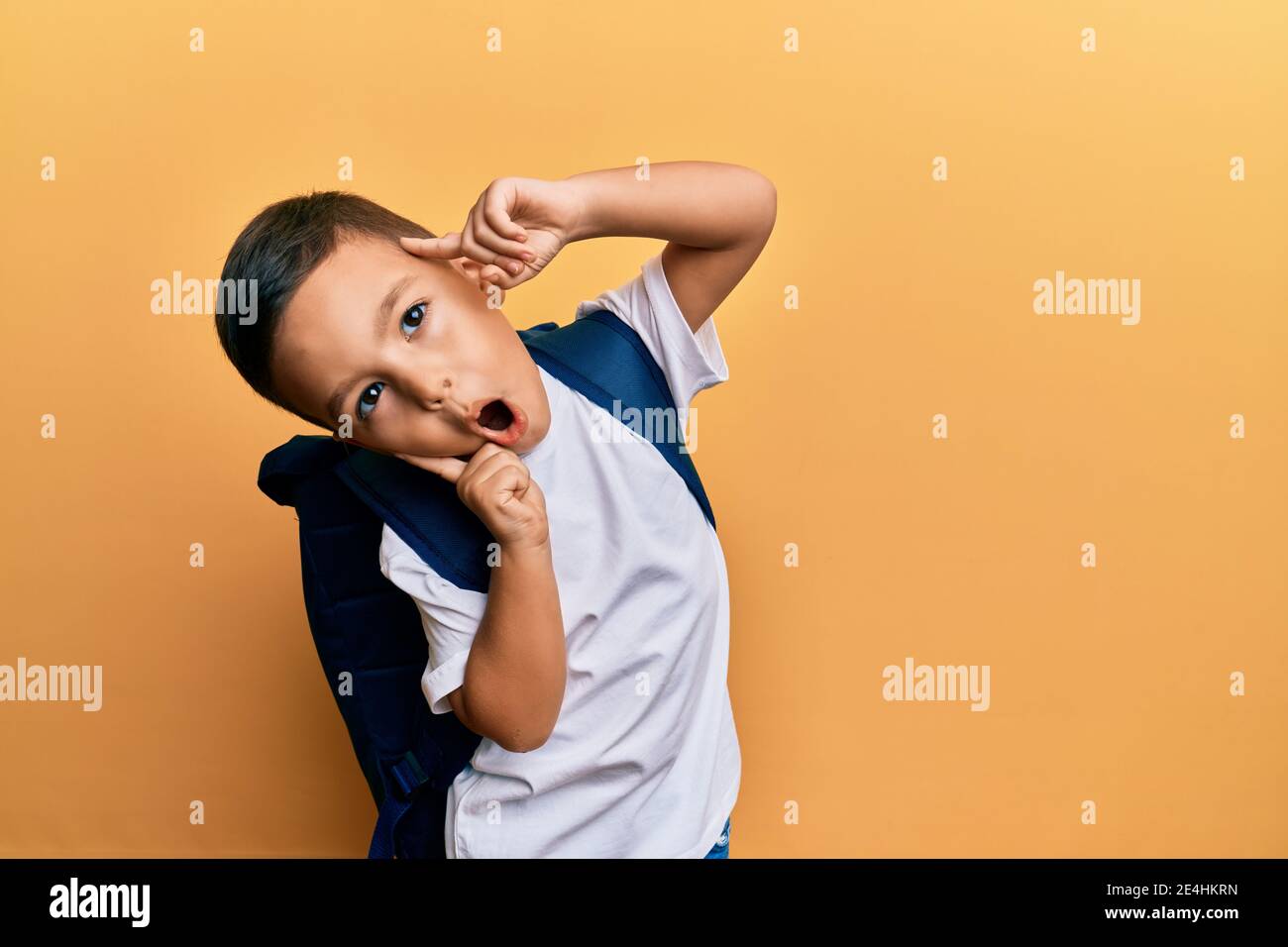 Adorable latin toddler smiling happy wearing student backpack over ...