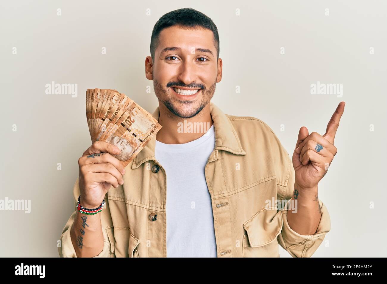 Handsome man with tattoos holding south african 20 rand banknotes ...