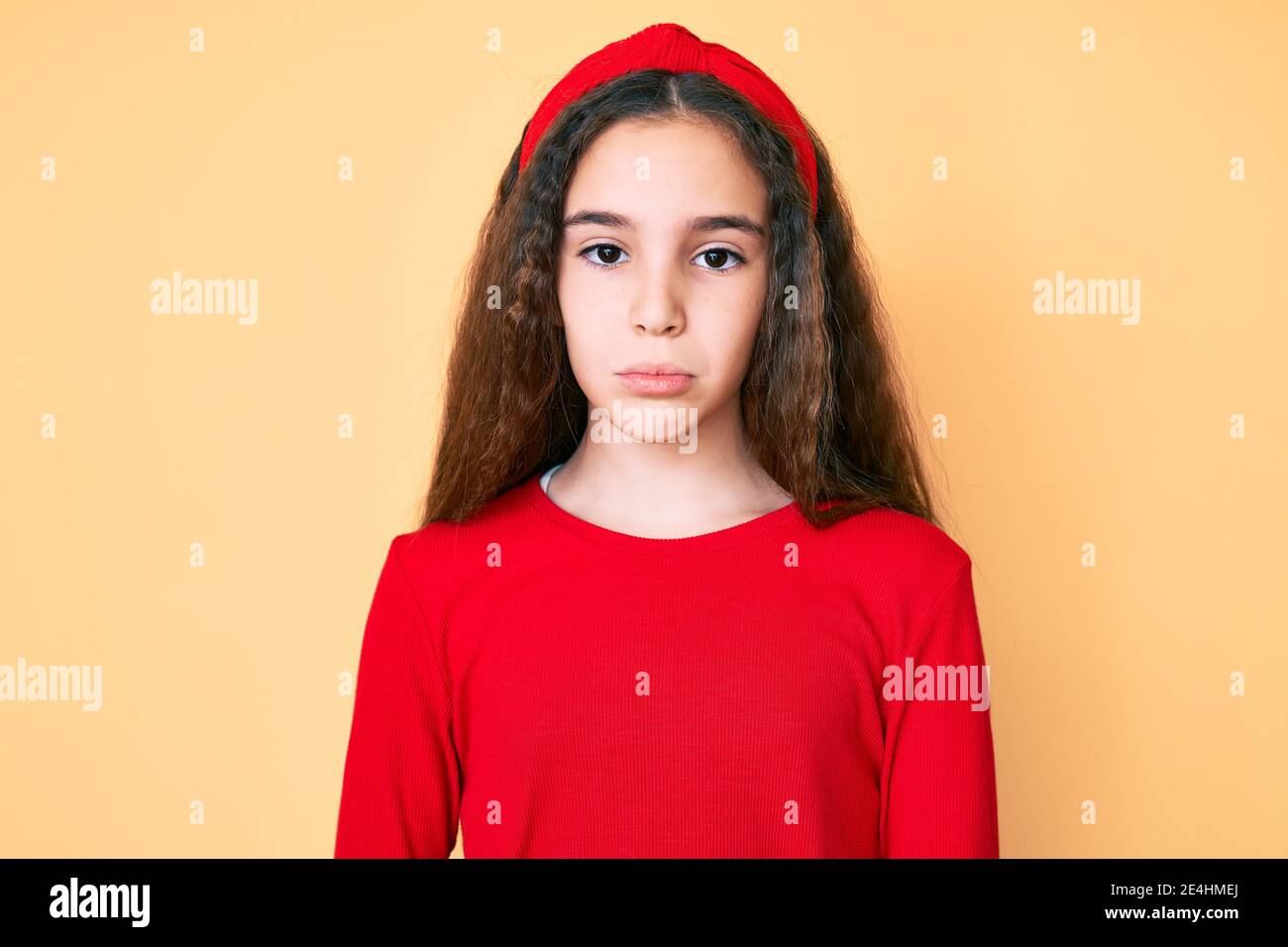 Cute hispanic child girl wearing casual clothes and diadem depressed ...