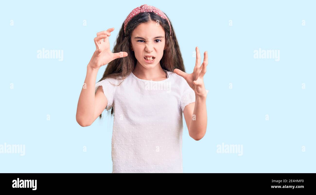 Cute hispanic child girl wearing casual white tshirt shouting ...