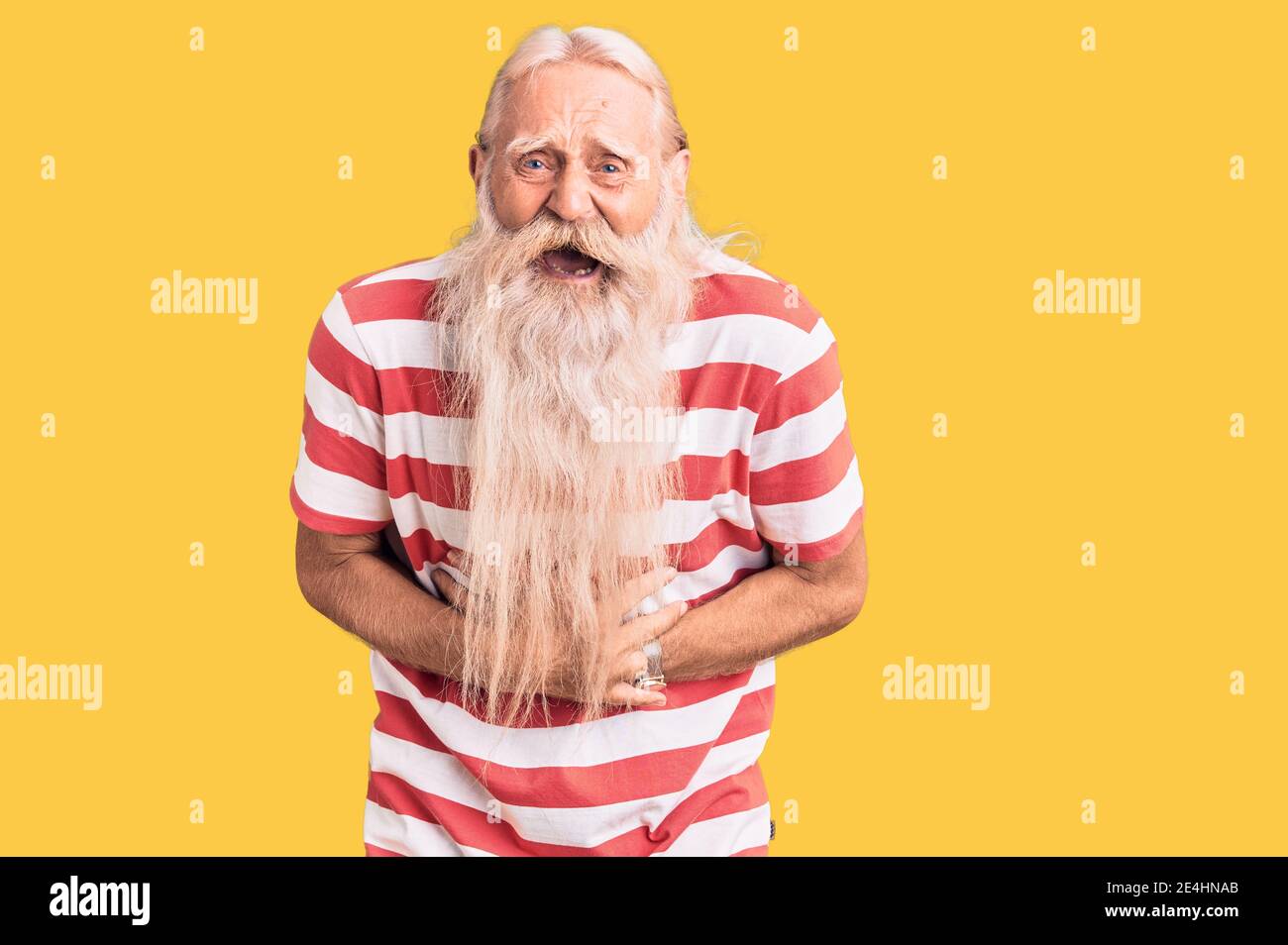 Old senior man with grey hair and long beard wearing striped tshirt ...