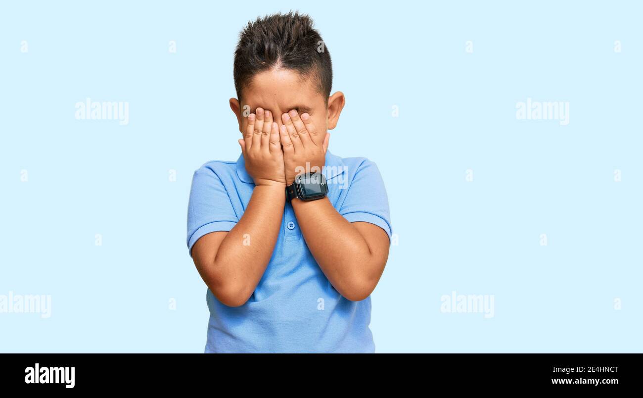 Little boy hispanic kid wearing casual clothes with sad expression ...