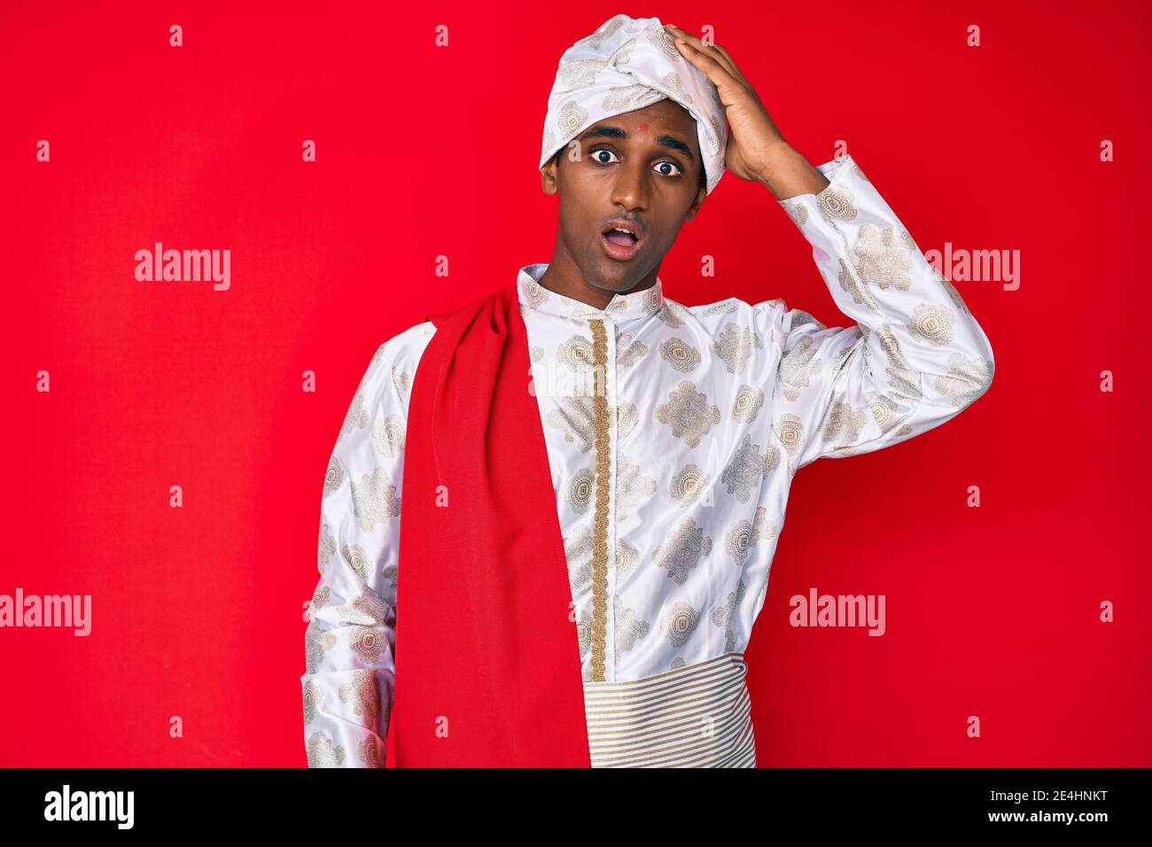 Handsome indian man wearing tradition sherwani saree clothes surprised ...