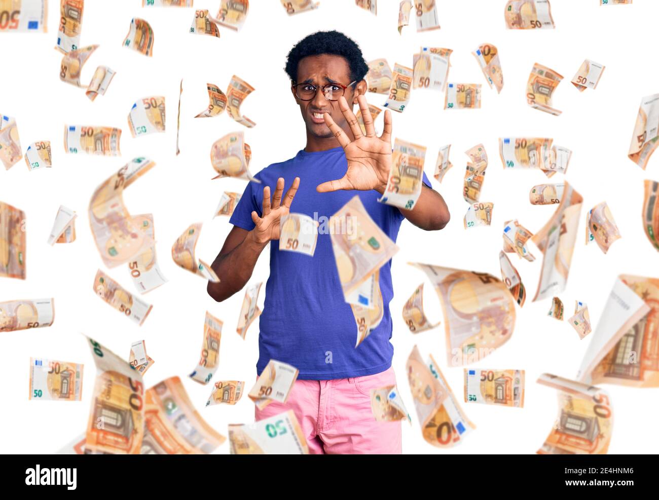 African handsome man wearing casual clothes and glasses afraid and ...