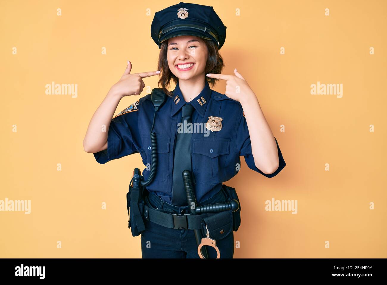 Young beautiful woman wearing police uniform smiling cheerful showing ...
