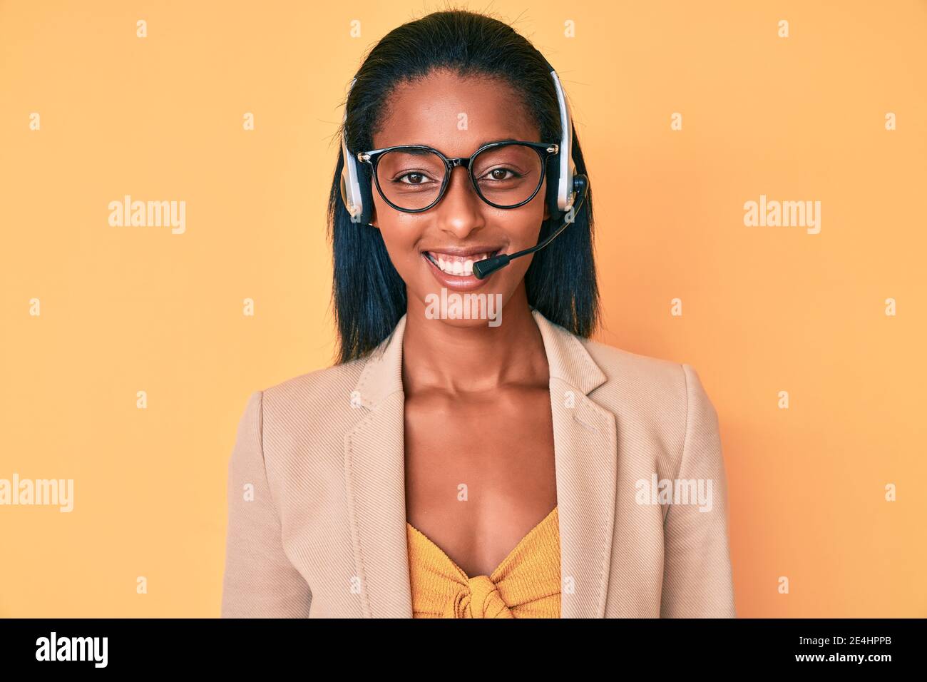 Young african american woman wearing call center agent headset smiling with a happy and cool ...