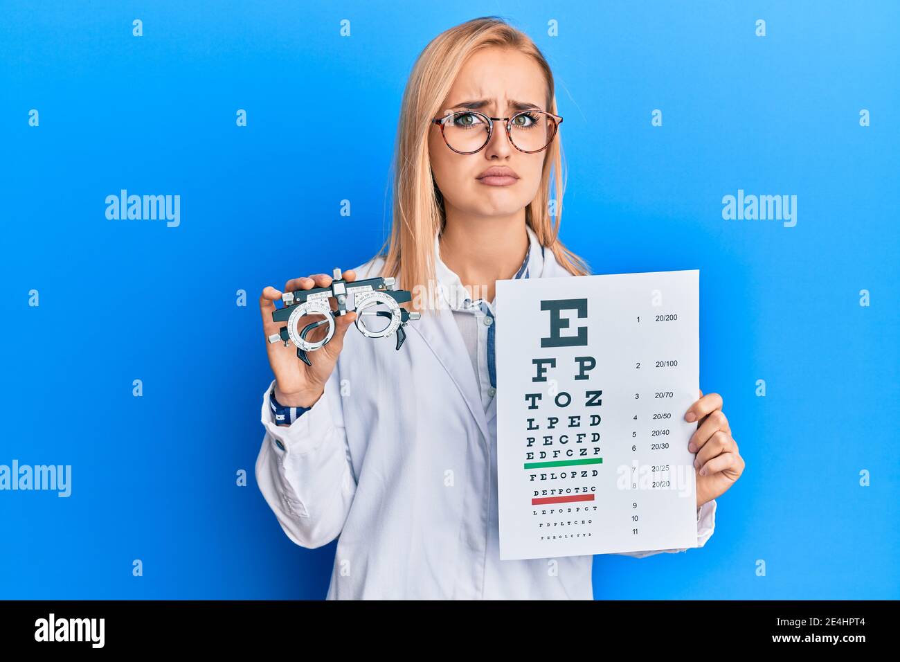 Beautiful caucasian optician woman holding optometry glasses and ...