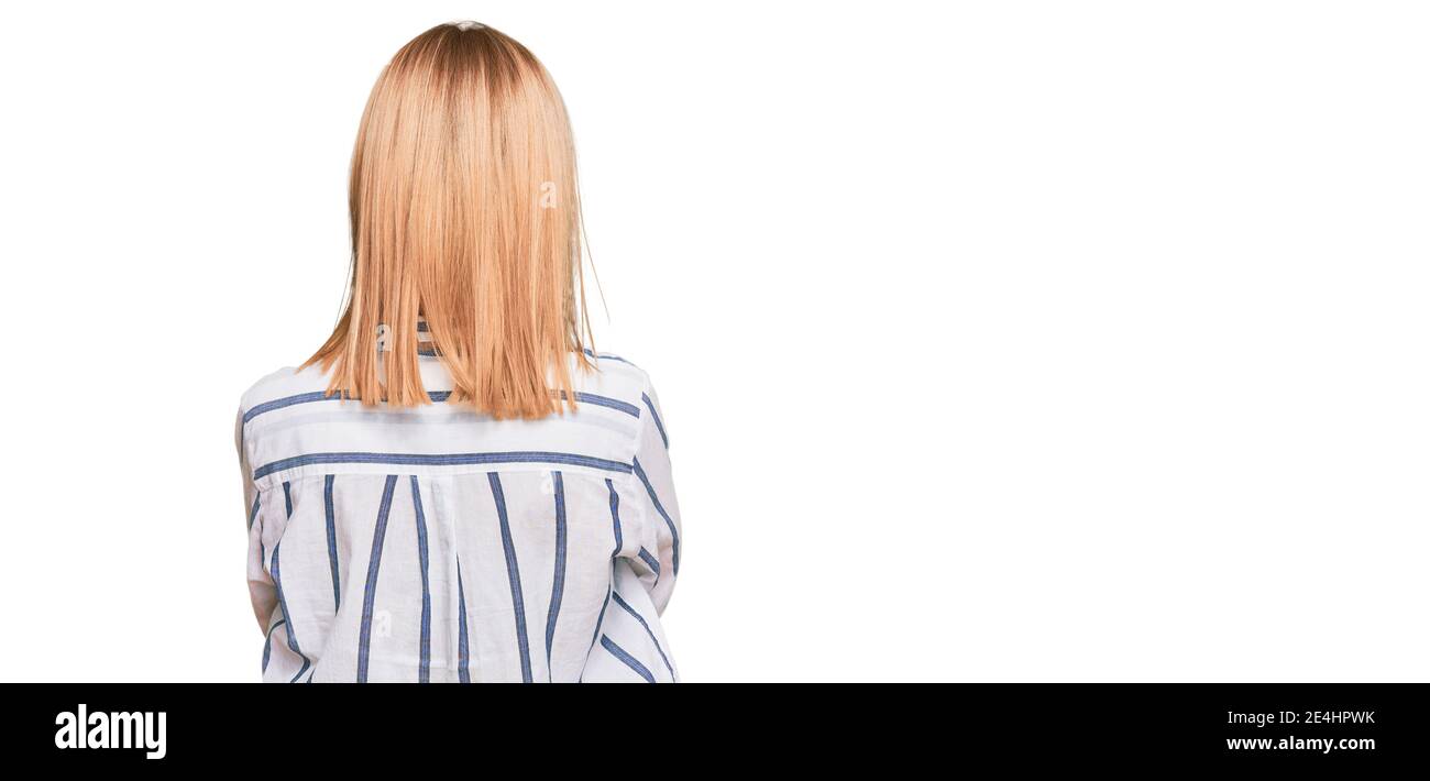 Beautiful caucasian woman wearing casual clothes standing backwards ...