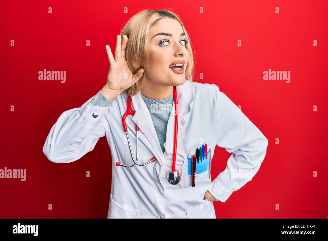 Young caucasian woman wearing doctor uniform and stethoscope smiling ...