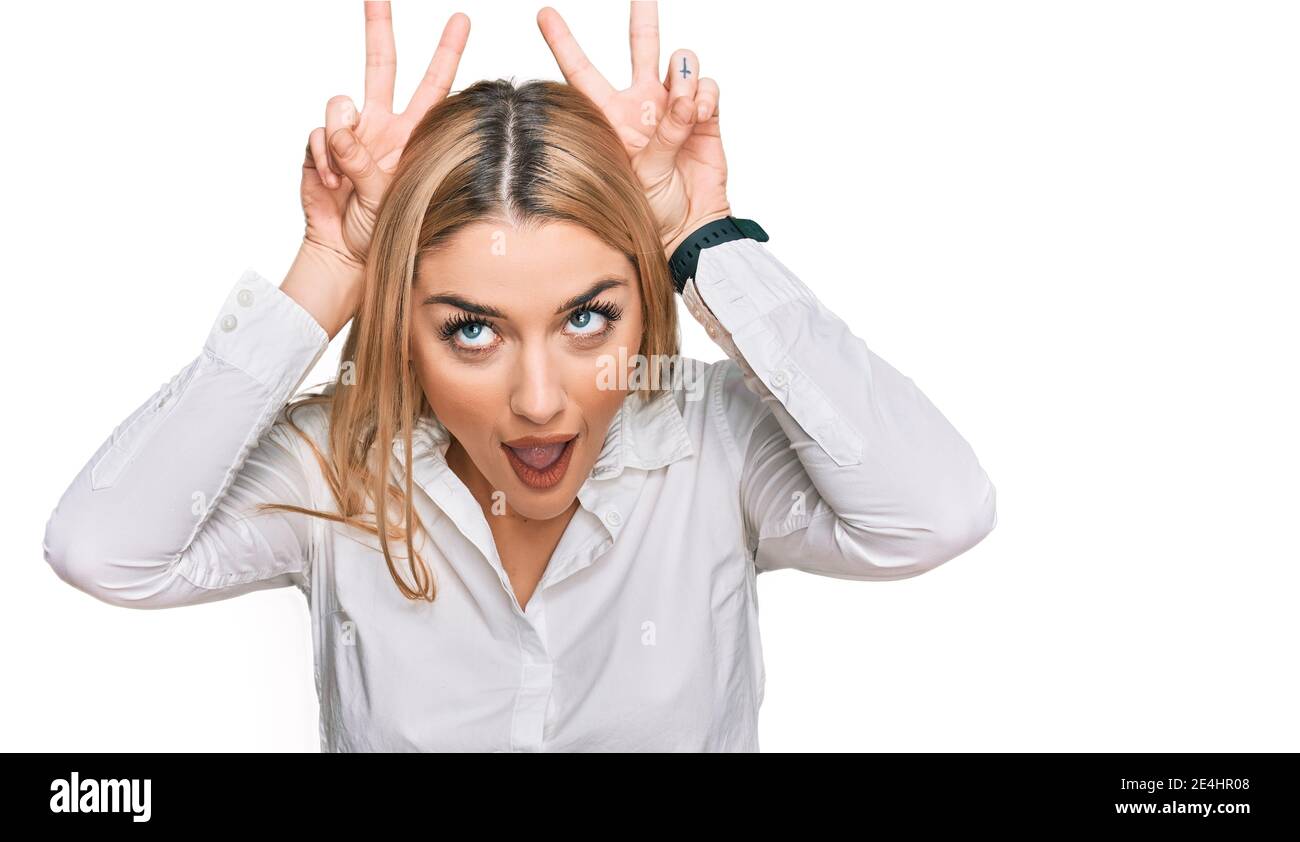 Young caucasian woman wearing casual clothes posing funny and crazy ...