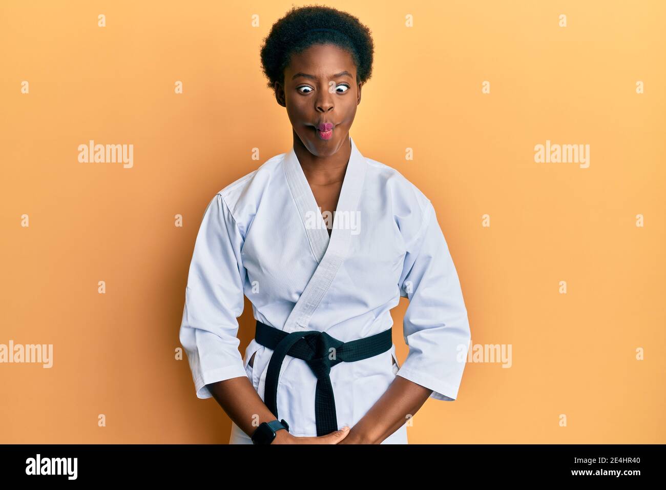 Young african american girl wearing karate kimono and black belt making ...