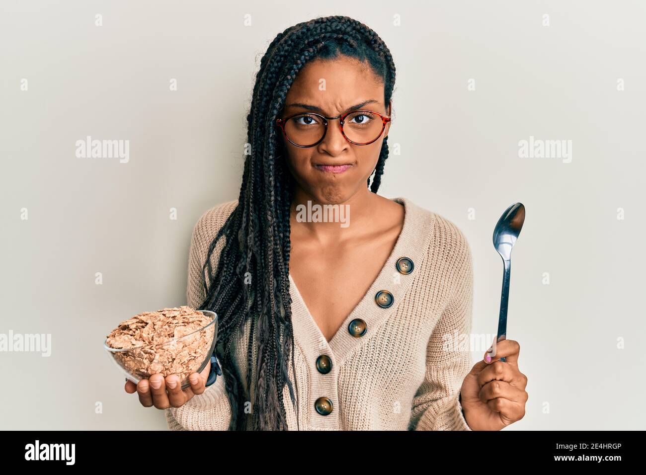 African american woman with braids eating healthy whole grain cereals ...