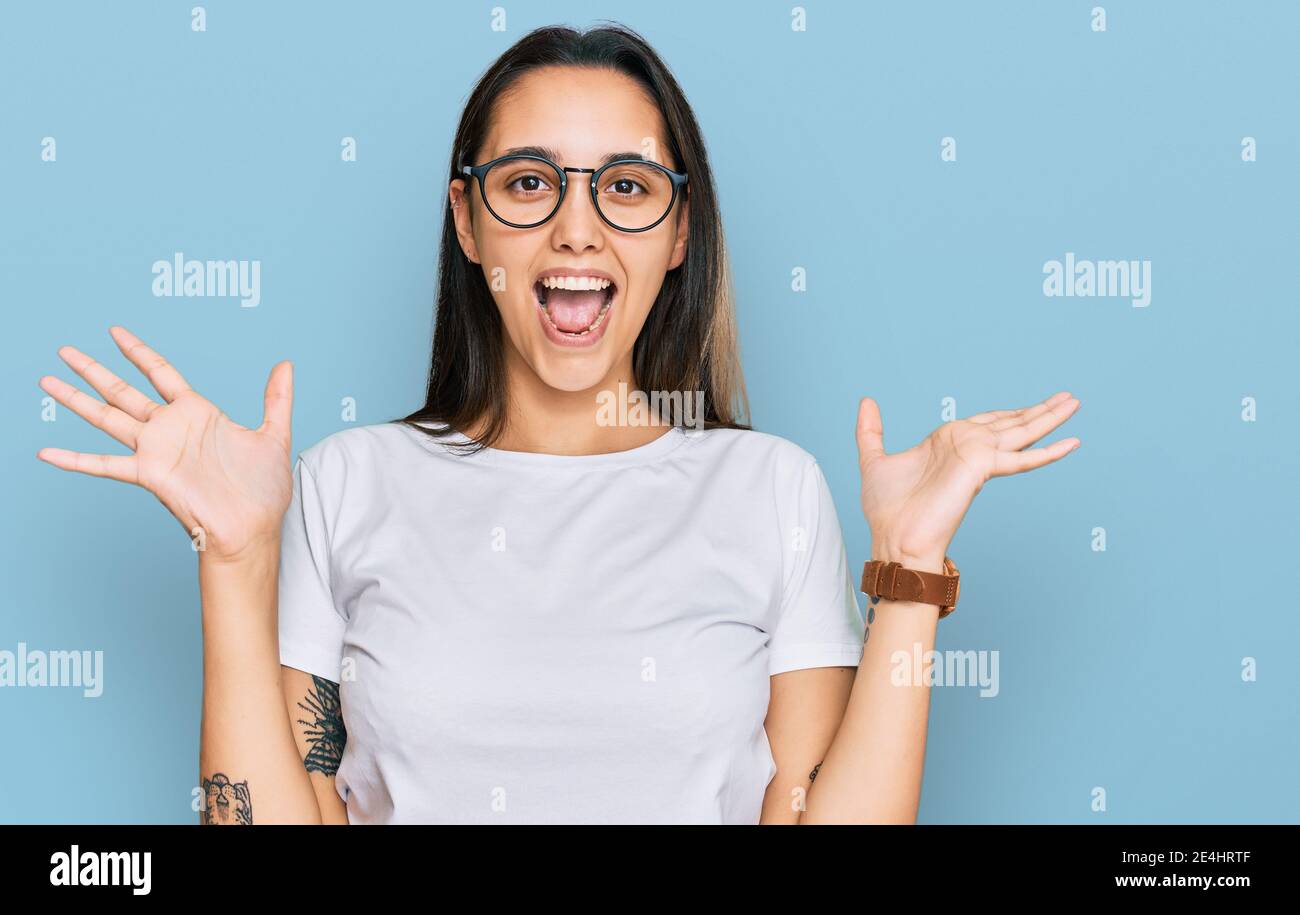 Young Hispanic Woman Wearing Casual White T Shirt Celebrating Crazy And