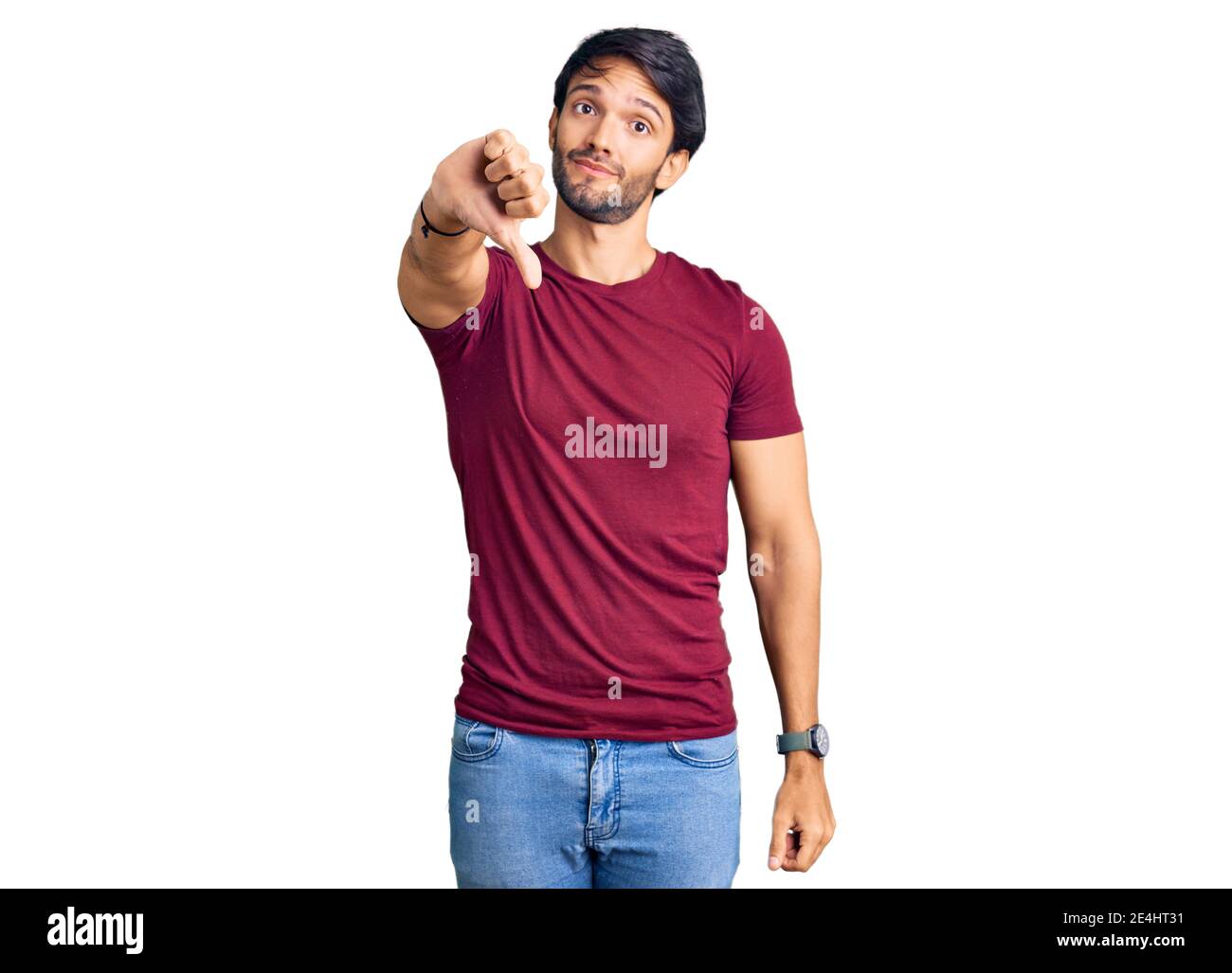 Handsome hispanic man wearing casual clothes looking unhappy and angry ...