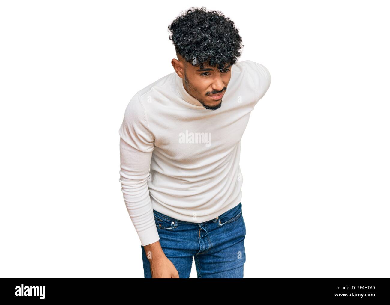 Young arab man wearing casual winter sweater suffering of backache ...