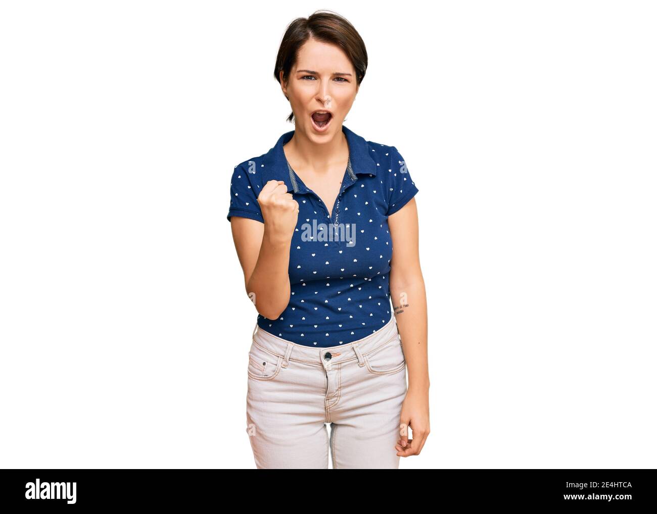 Young brunette woman with short hair wearing casual clothes angry and ...