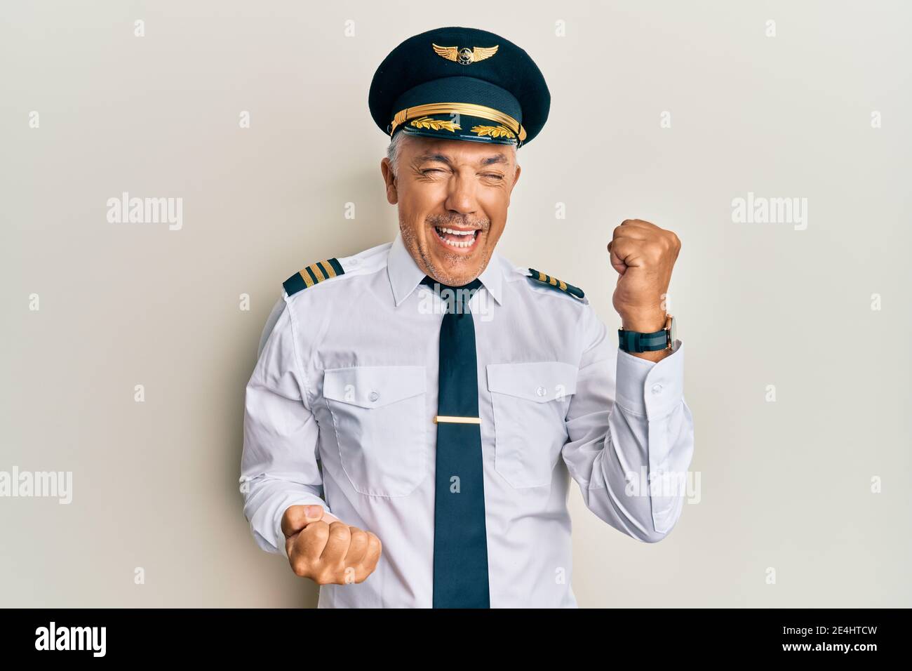 Handsome middle age mature man wearing airplane pilot uniform ...